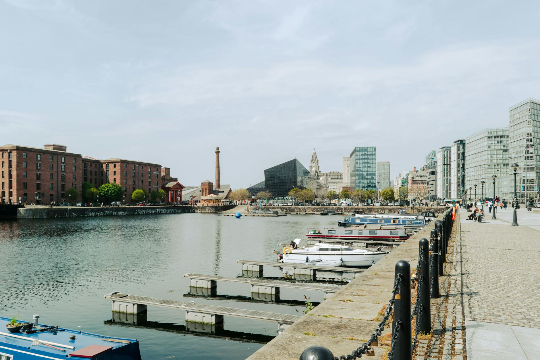 Boats moored at Liverpool Albert Dock with historic warehouse buildings