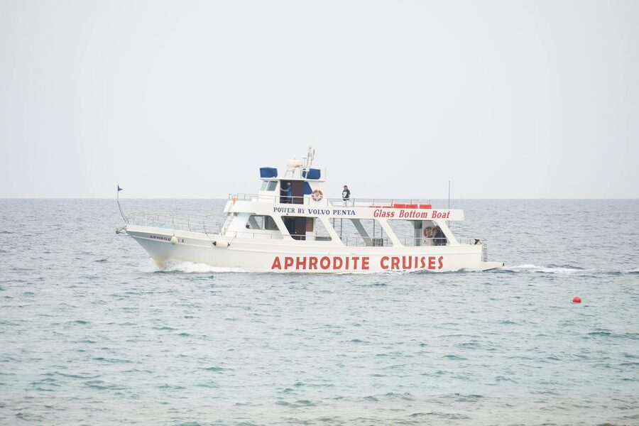 Empty cruise deck with lifeboats overlooking calm ocean horizon