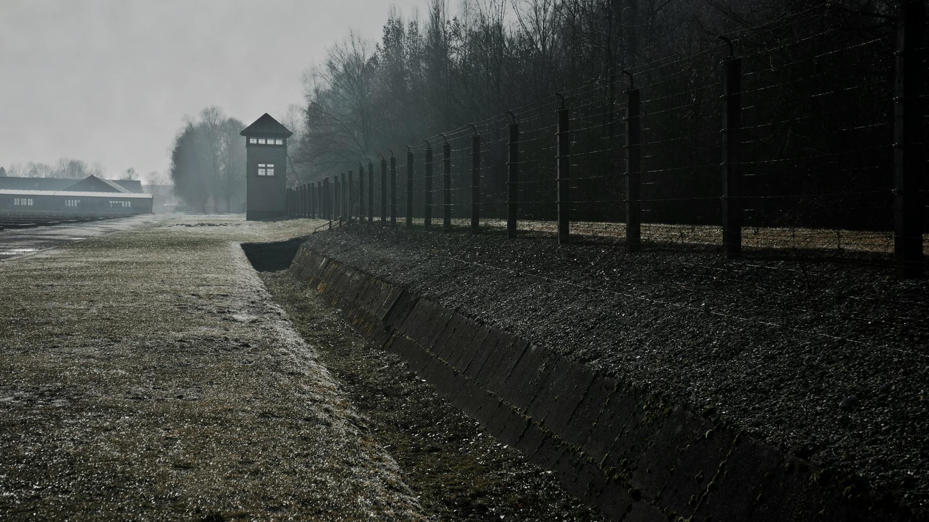 Barbed wire fence and watchtower at Dachau memorial