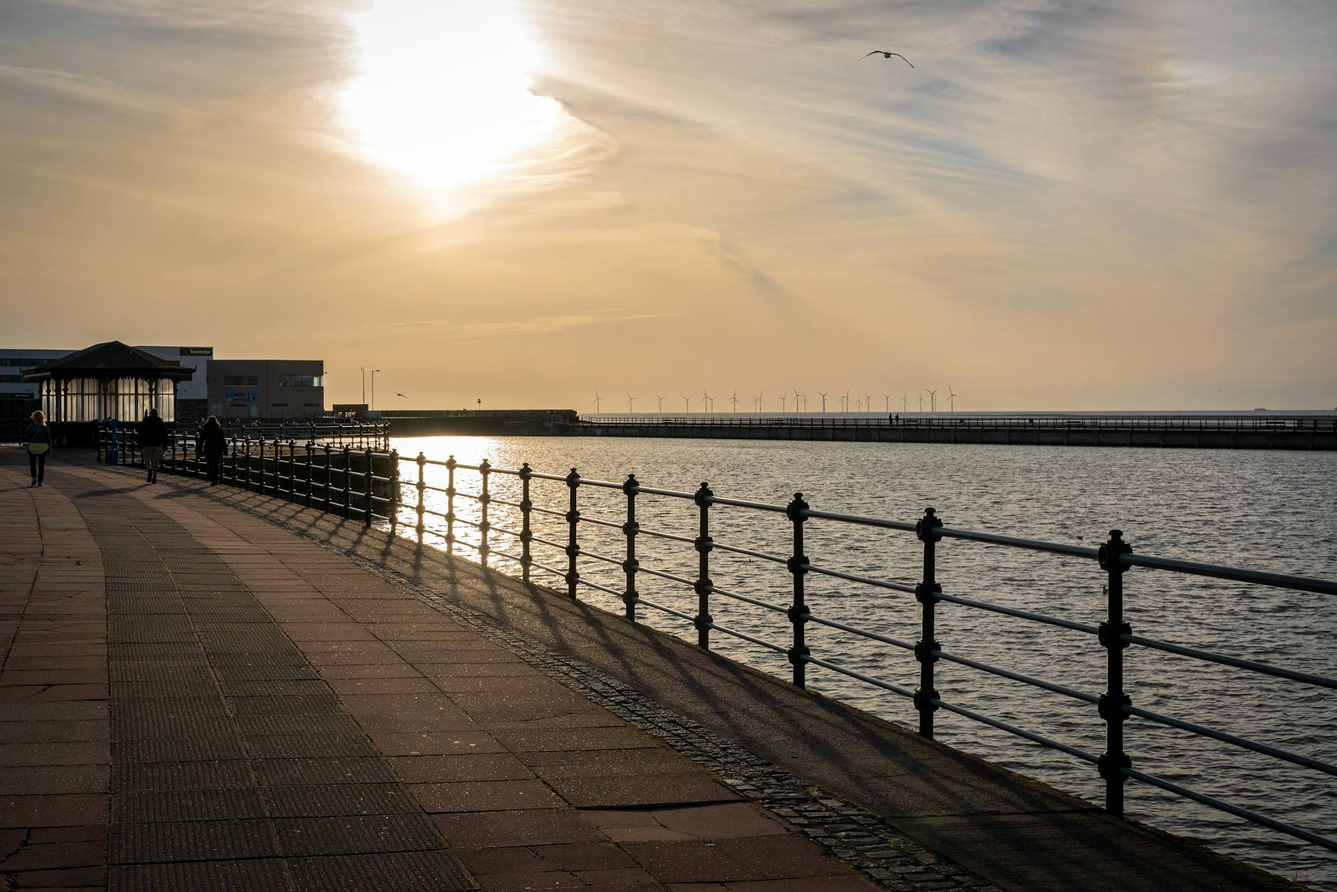 Beautiful sunset at Wallasey promenade with wind turbines across the River Mersey