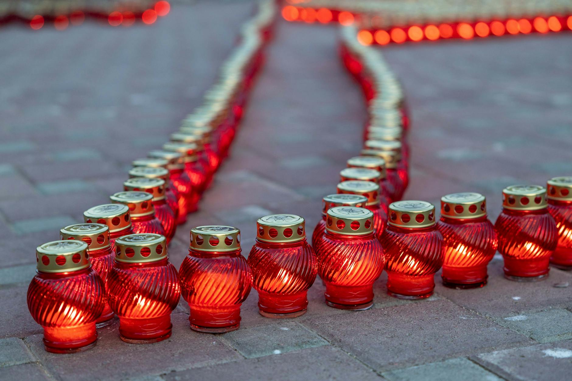 Rows of memorial candles creating warm remembrance