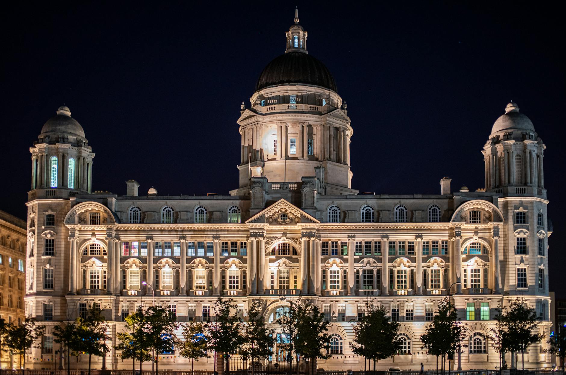 Port of Liverpool Building beautifully lit at night along the waterfront